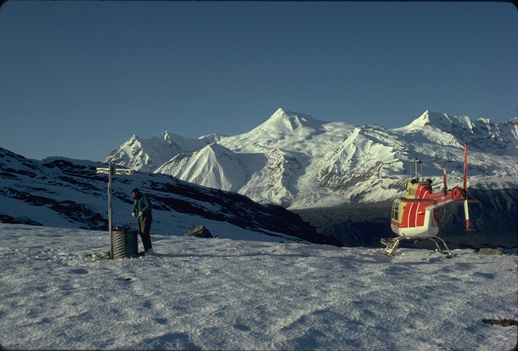 Scientist performs maintenance at a seismic station near Spurr Volcano ...