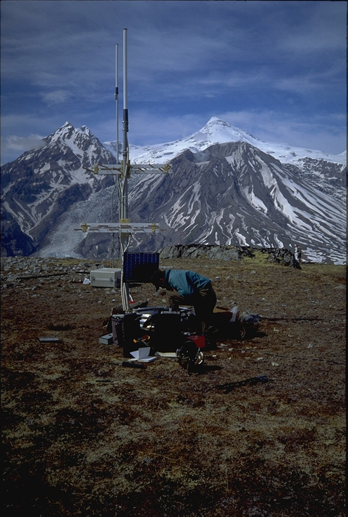 Scientist performs maintenance at a seismic station near Spurr Volcano ...