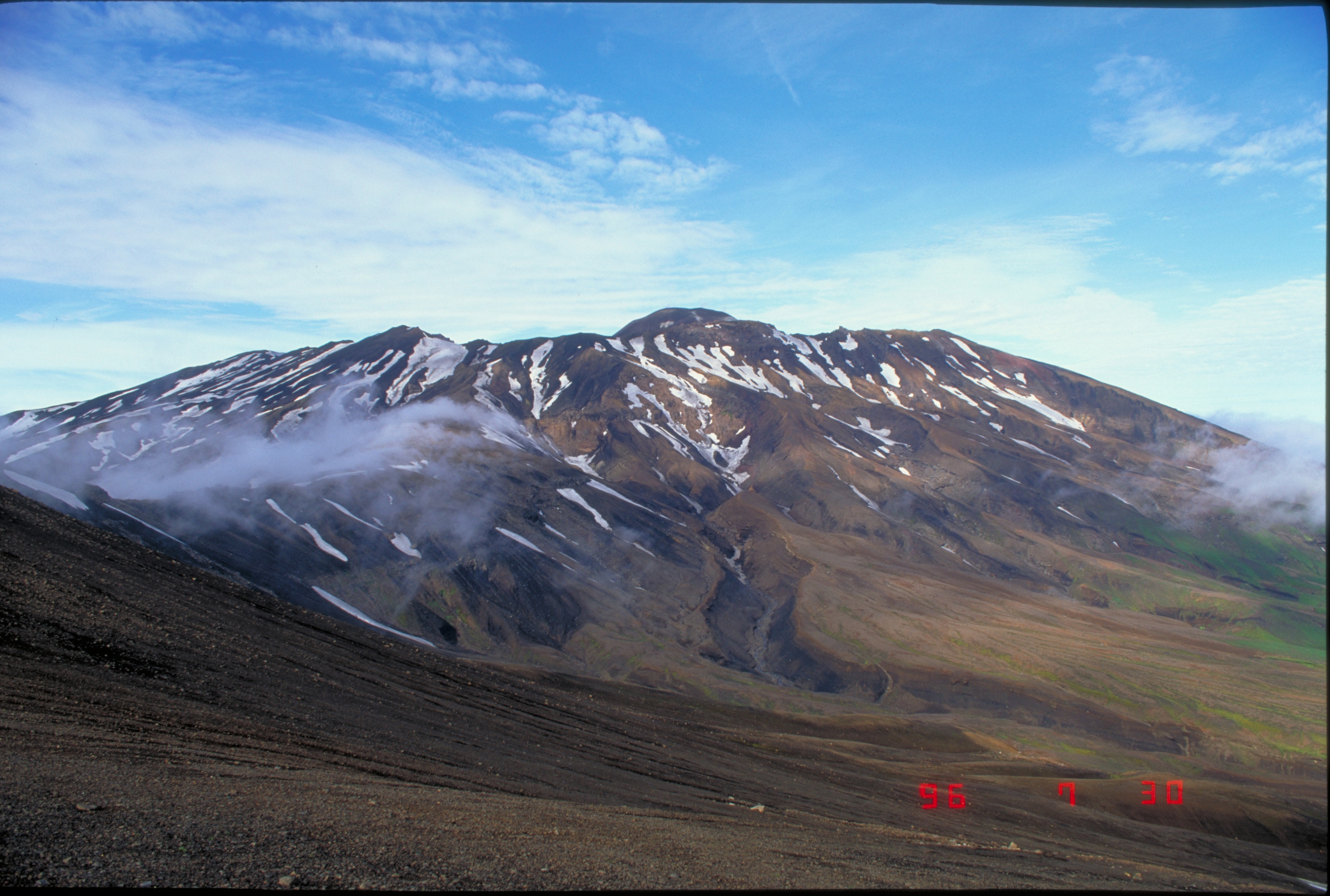 East flank of Akutan Volcano. Top of intracaldera cinder cone is ...