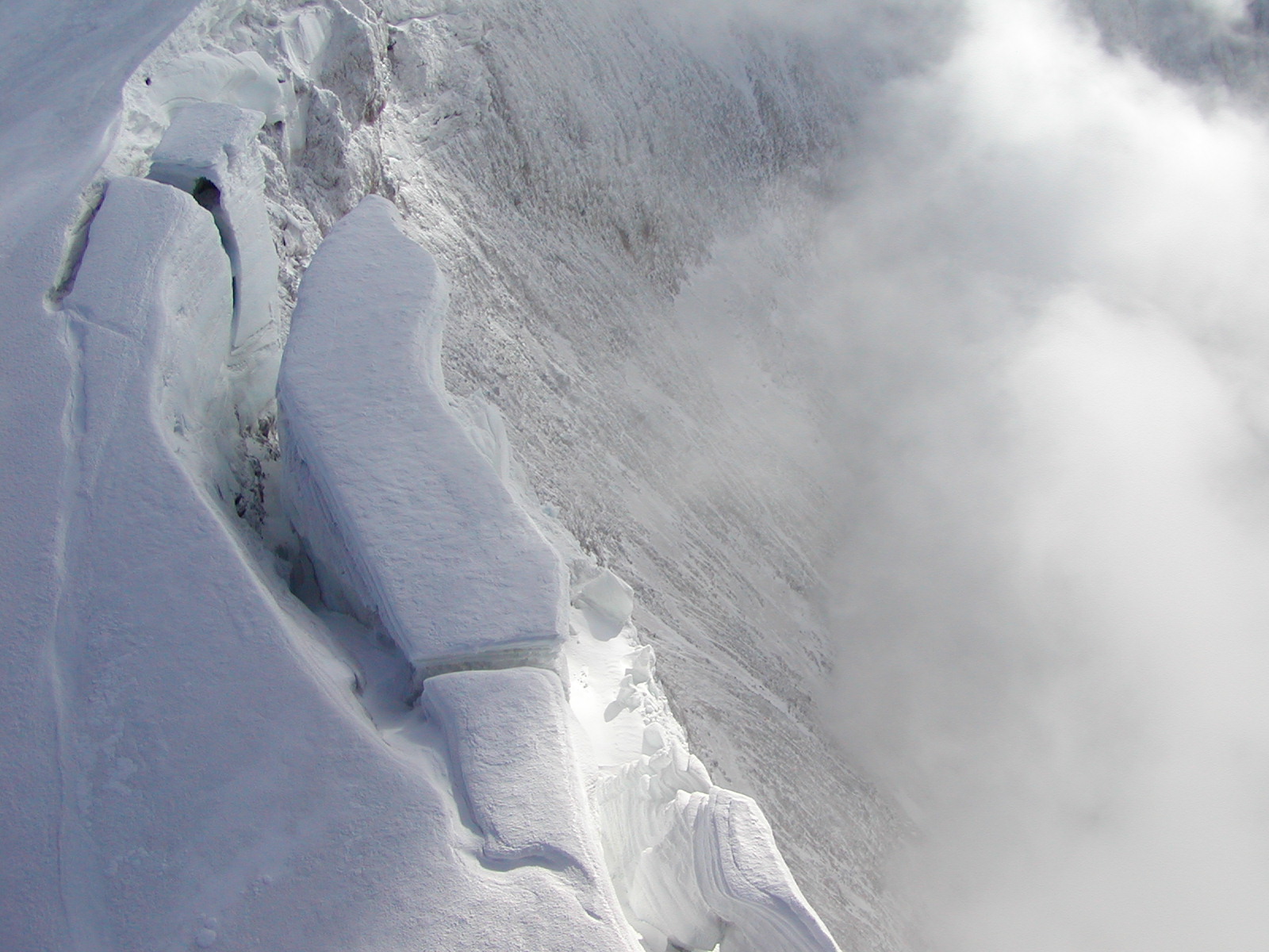 Large ice blocks are perched on the crater rim as gas and steam rise ...