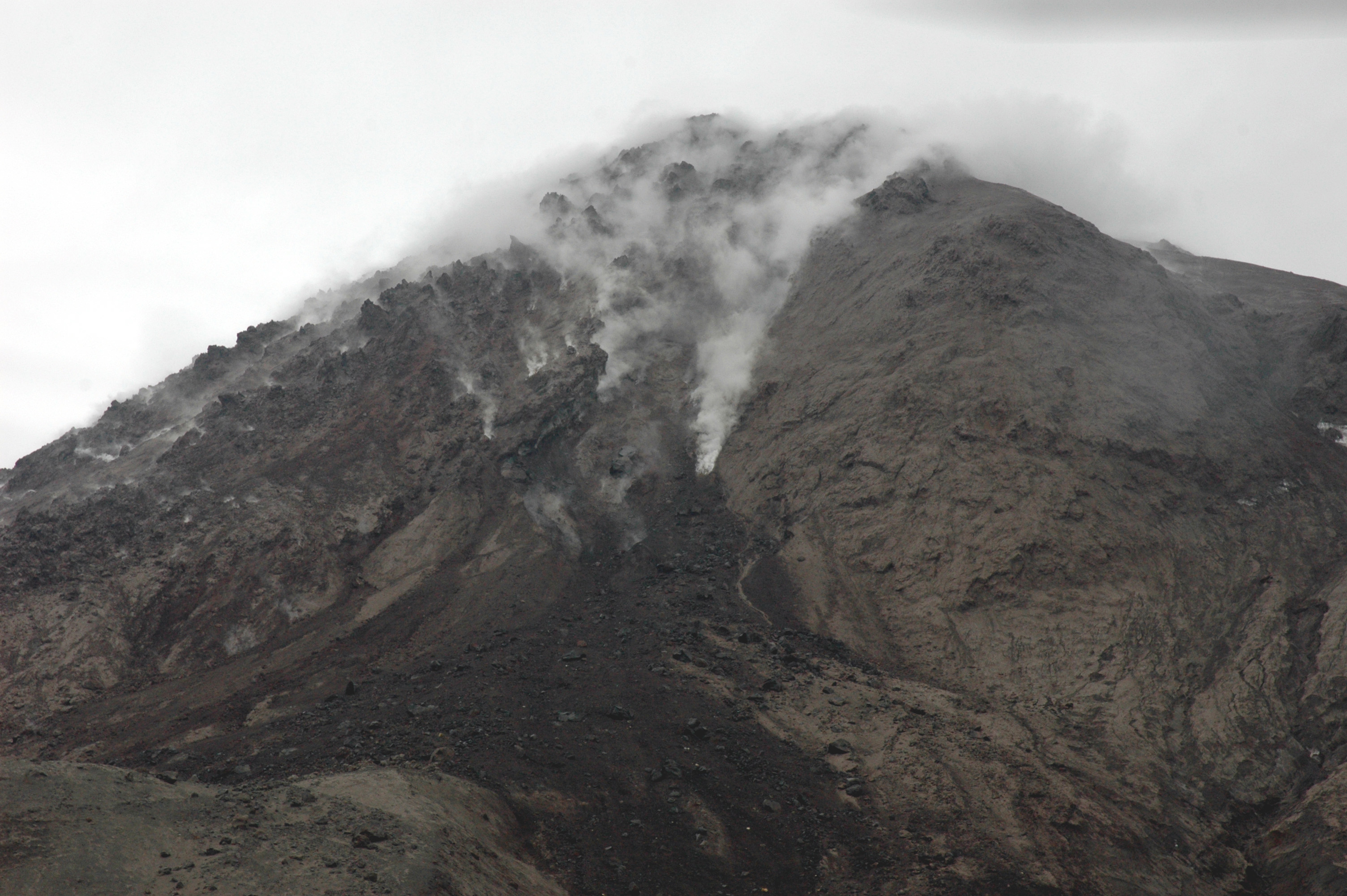 Upper northwest flank of Augustine volcano showing the source chute of ...