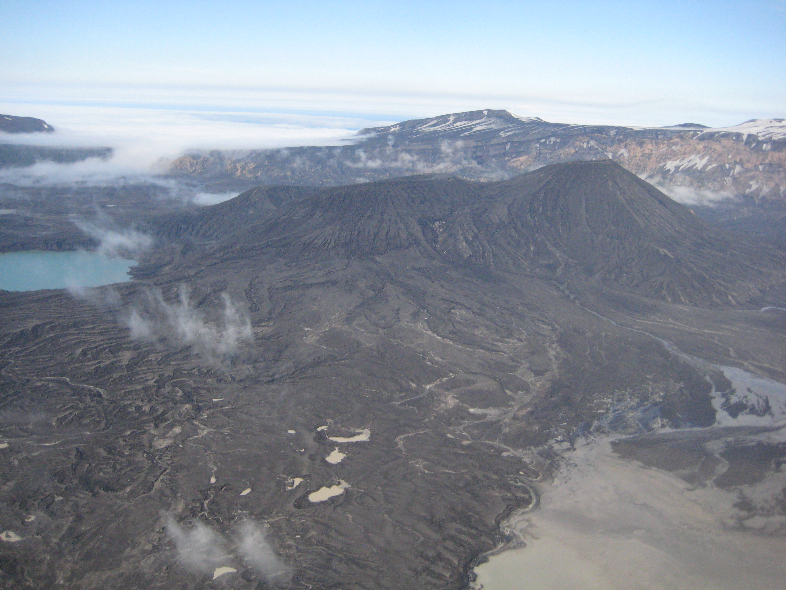 Okmok, 2010. View of Okmok caldera from the south. Note fog flowing ...