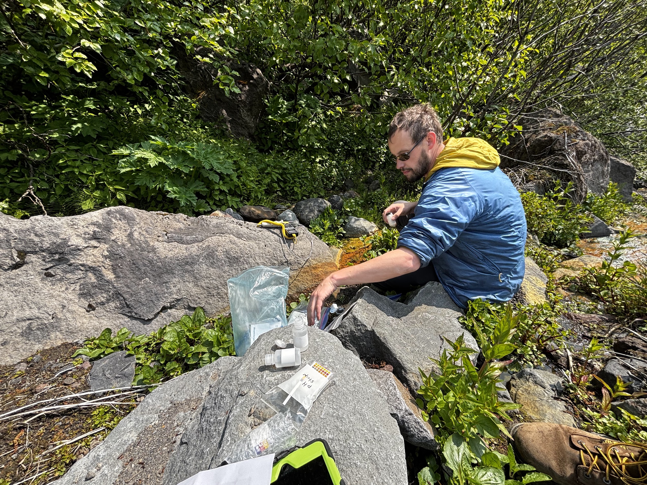 AVO Geologist M. Loewen sampling water from Crater Creek just south of ...