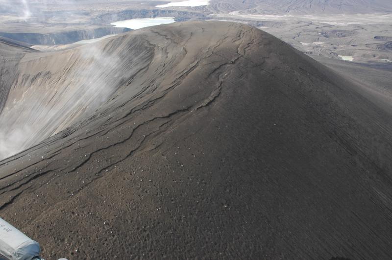 Rim of the new tephra cone showing ballistics and impact craters, a ...