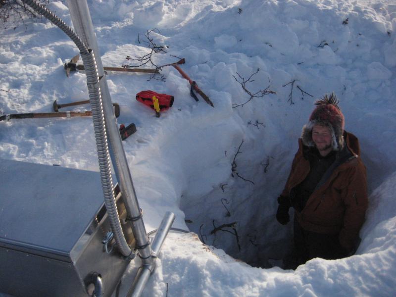 Cyrus Read standing in a snow pit dug for the installation of seismic ...