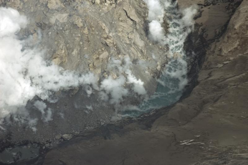 Close view of the roiling and steaming water that is ponded along the ...