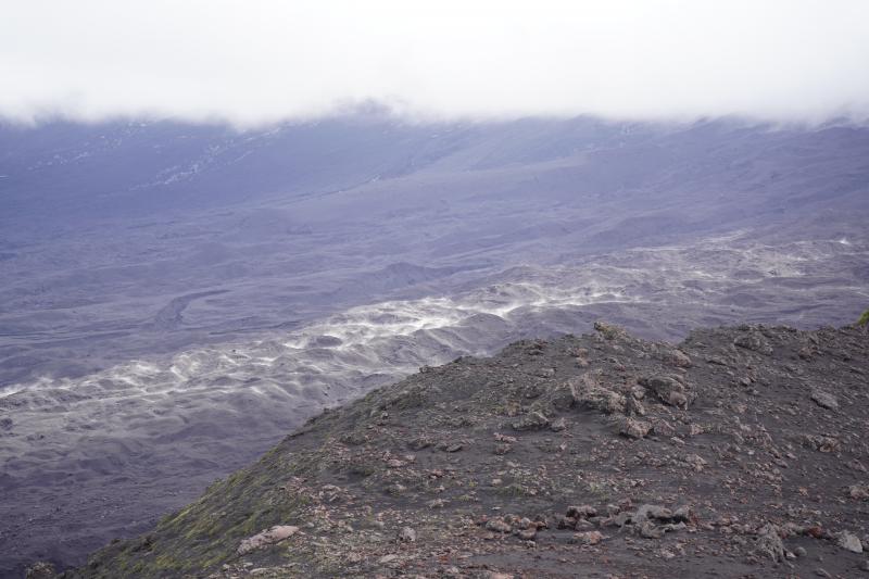 Ash-covered glacier and old lava flows near AVO site SSLN. Steam rising ...